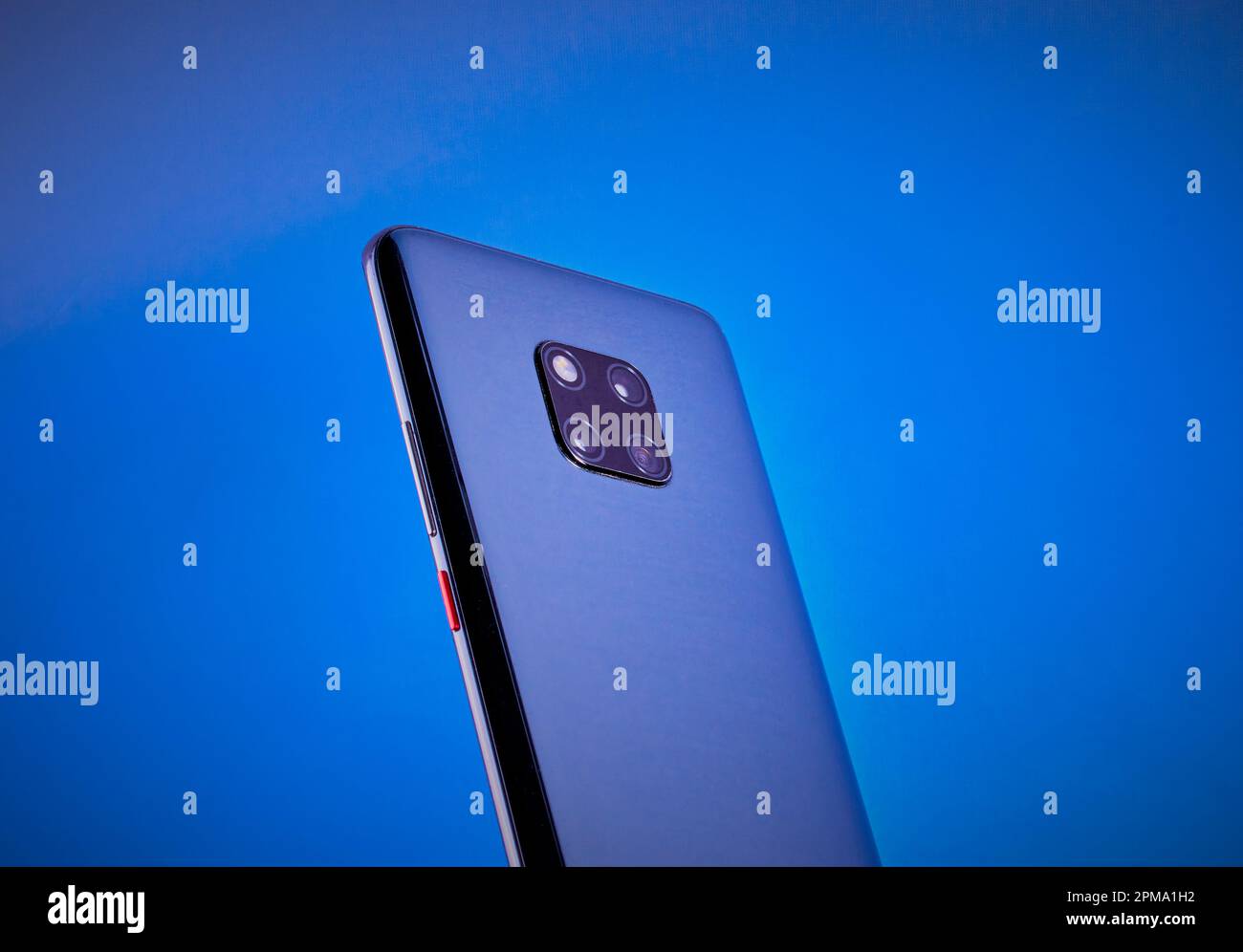 Back of a smart phone showing its cameras isolated on a blue gradient ...