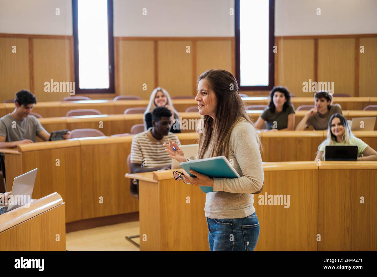 University professor explaining to her students in a circular-shaped ...