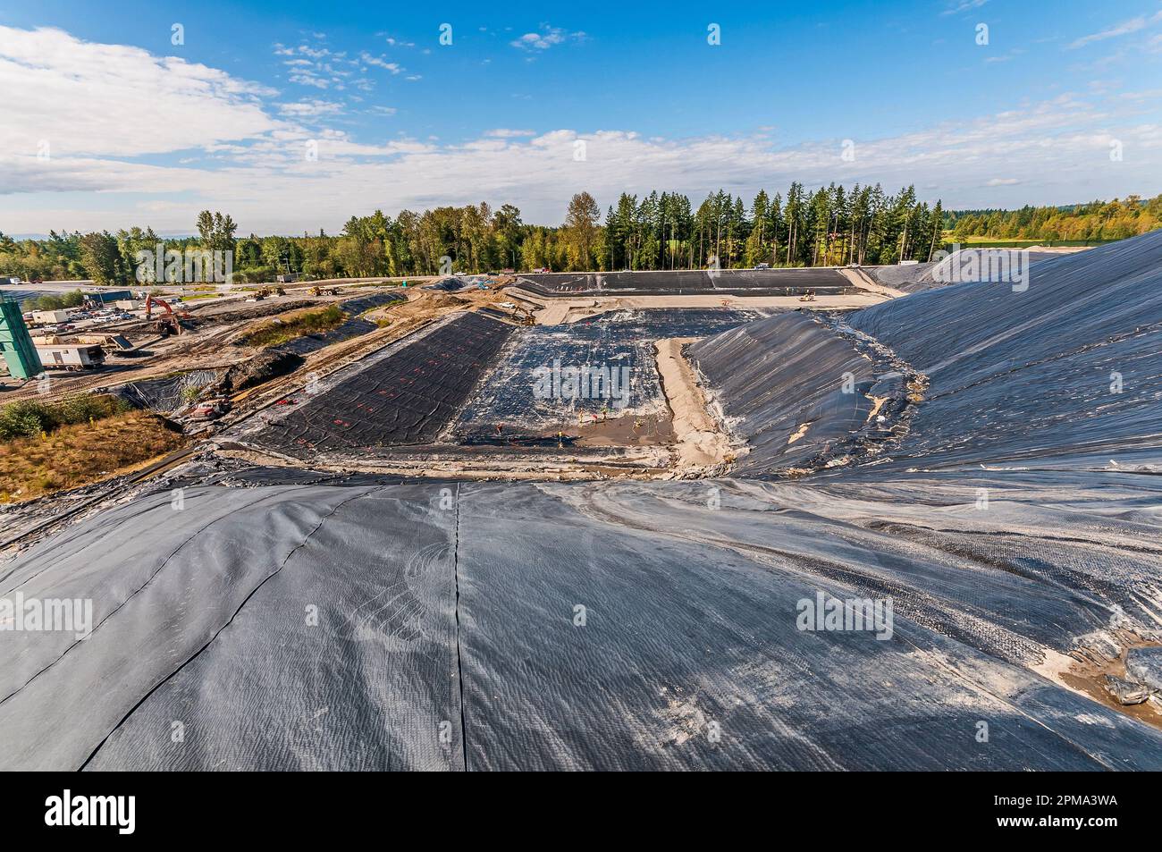 Geomembranes on hills and excavations in the distance below in an ...