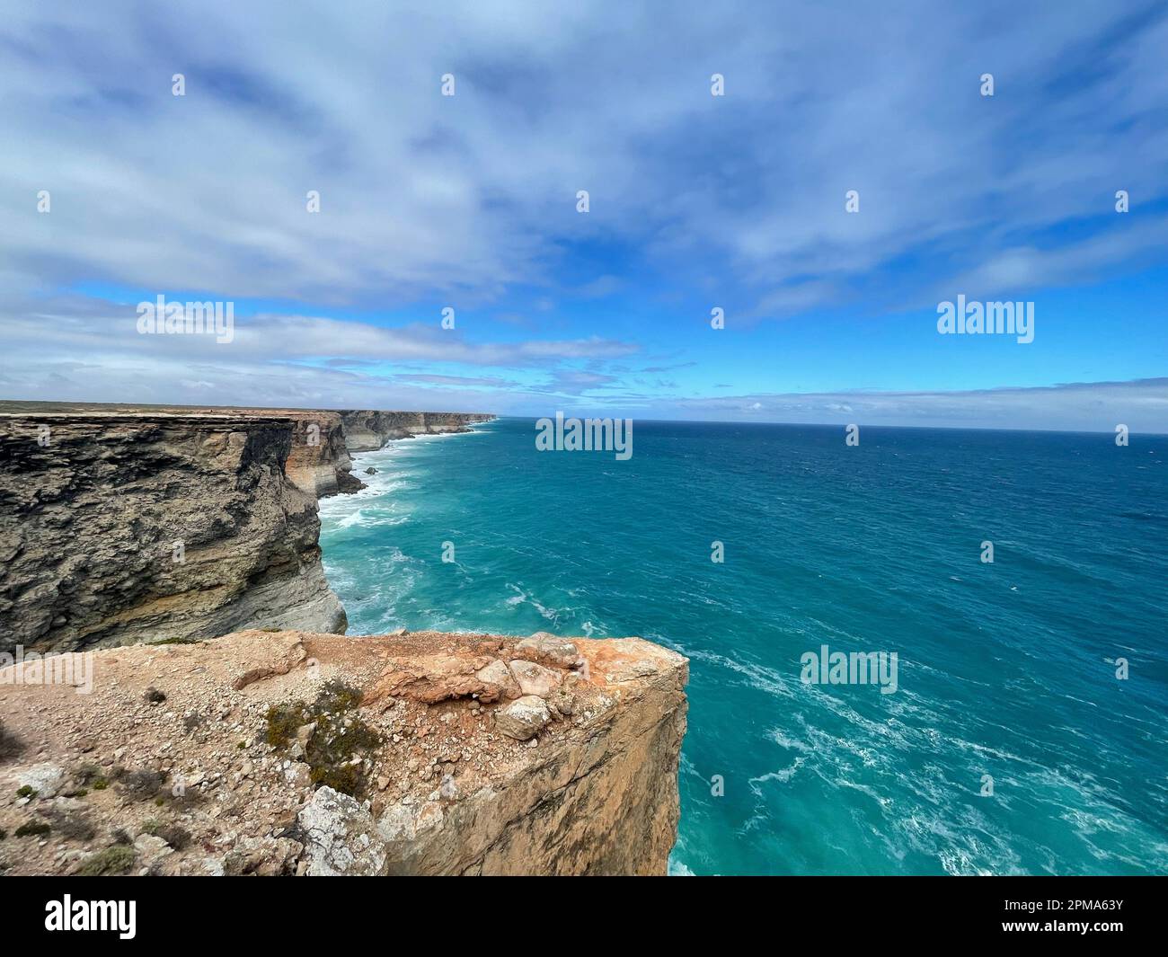 A scenic view of the ocean waves crashing against the rugged cliffs ...