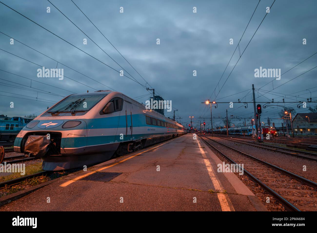 Passenger trains in station in cloudy spring morning in capital ...