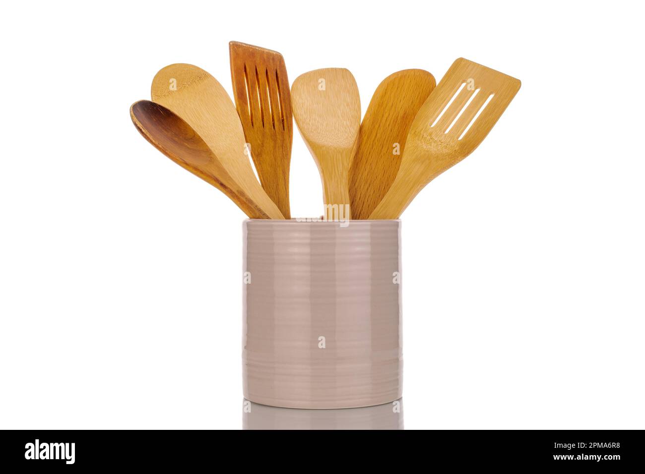 Several wooden spoons for the kitchen in a ceramic dish, macro ...