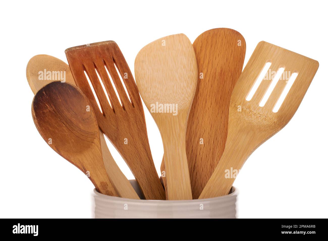 Several wooden spoons for the kitchen in a ceramic dish, macro ...