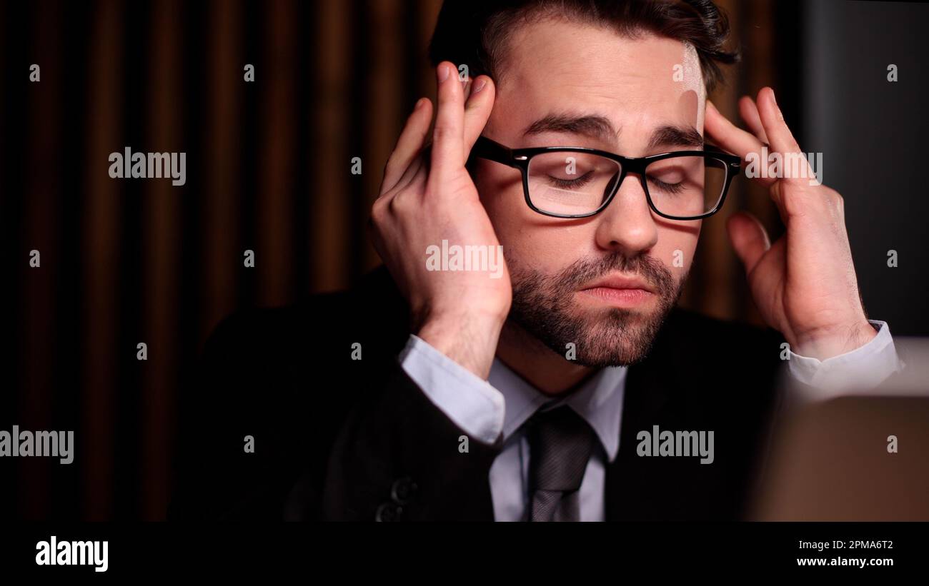 Tired exhausted man, office worker, manager or freelancer, sitting at ...