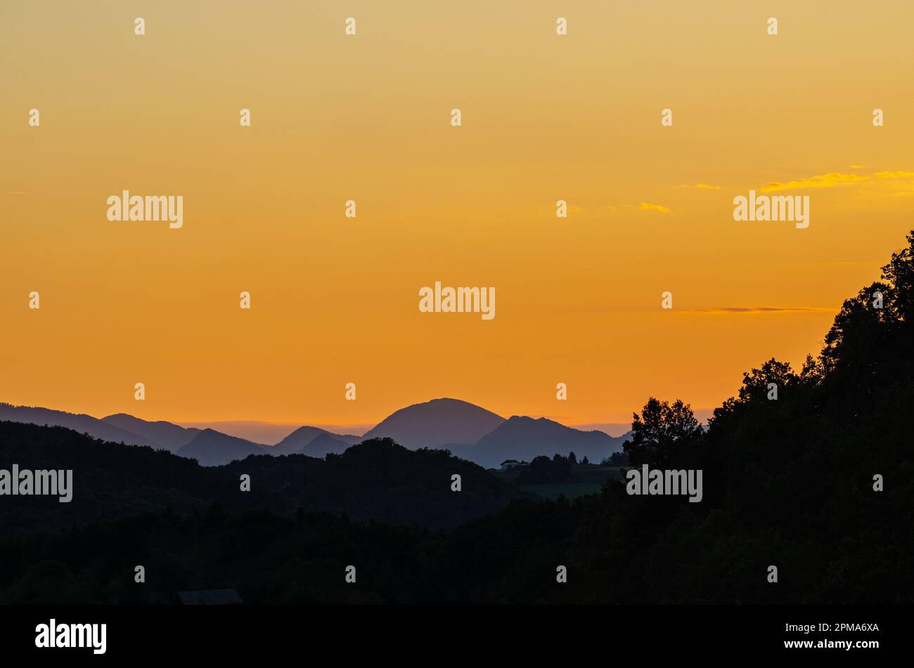 A beautiful orange sunset with a silhouette of the mountains. Dramatic ...