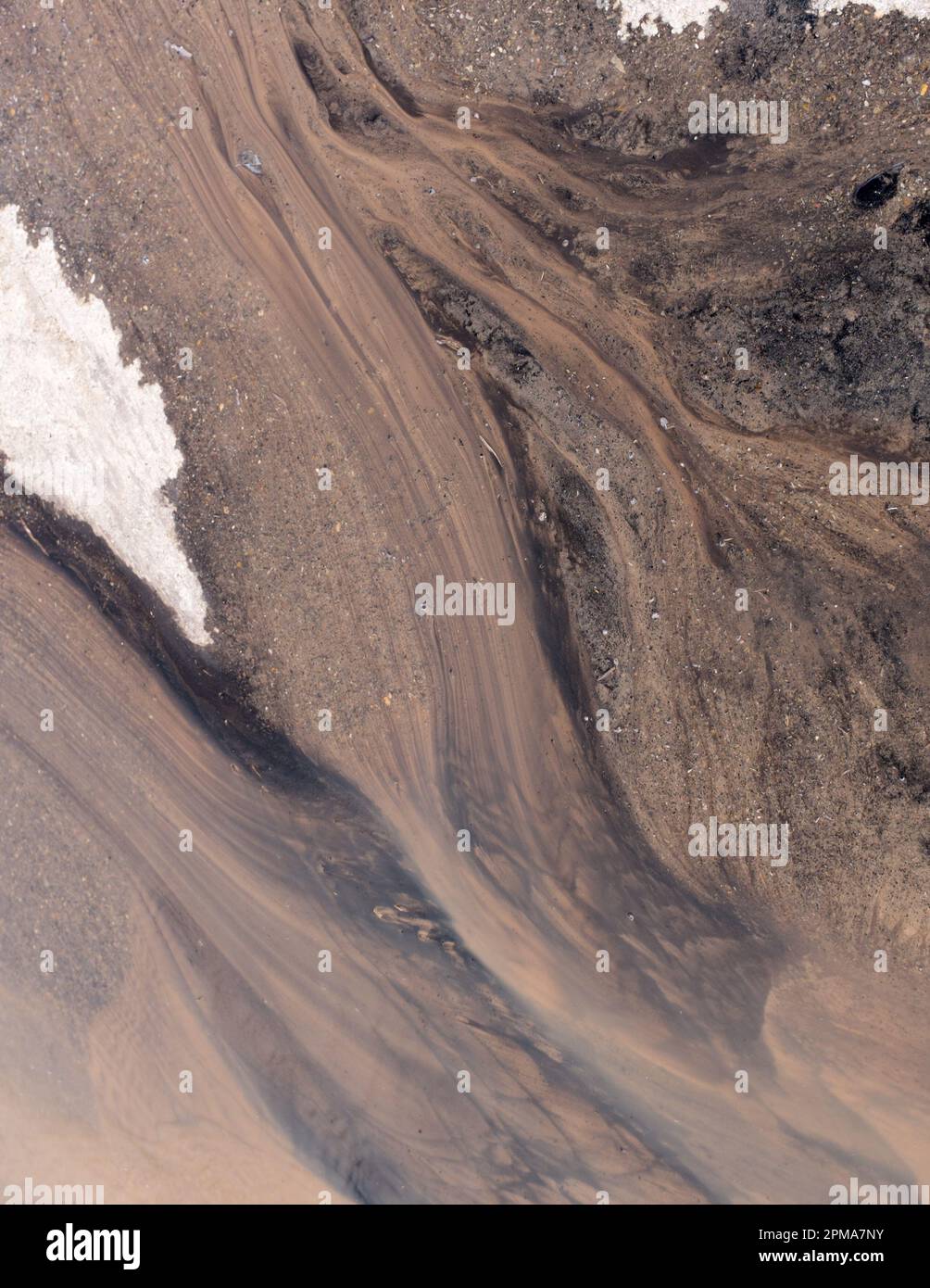 Spring melting creates interesting mud flows as gravity pulls the water ...