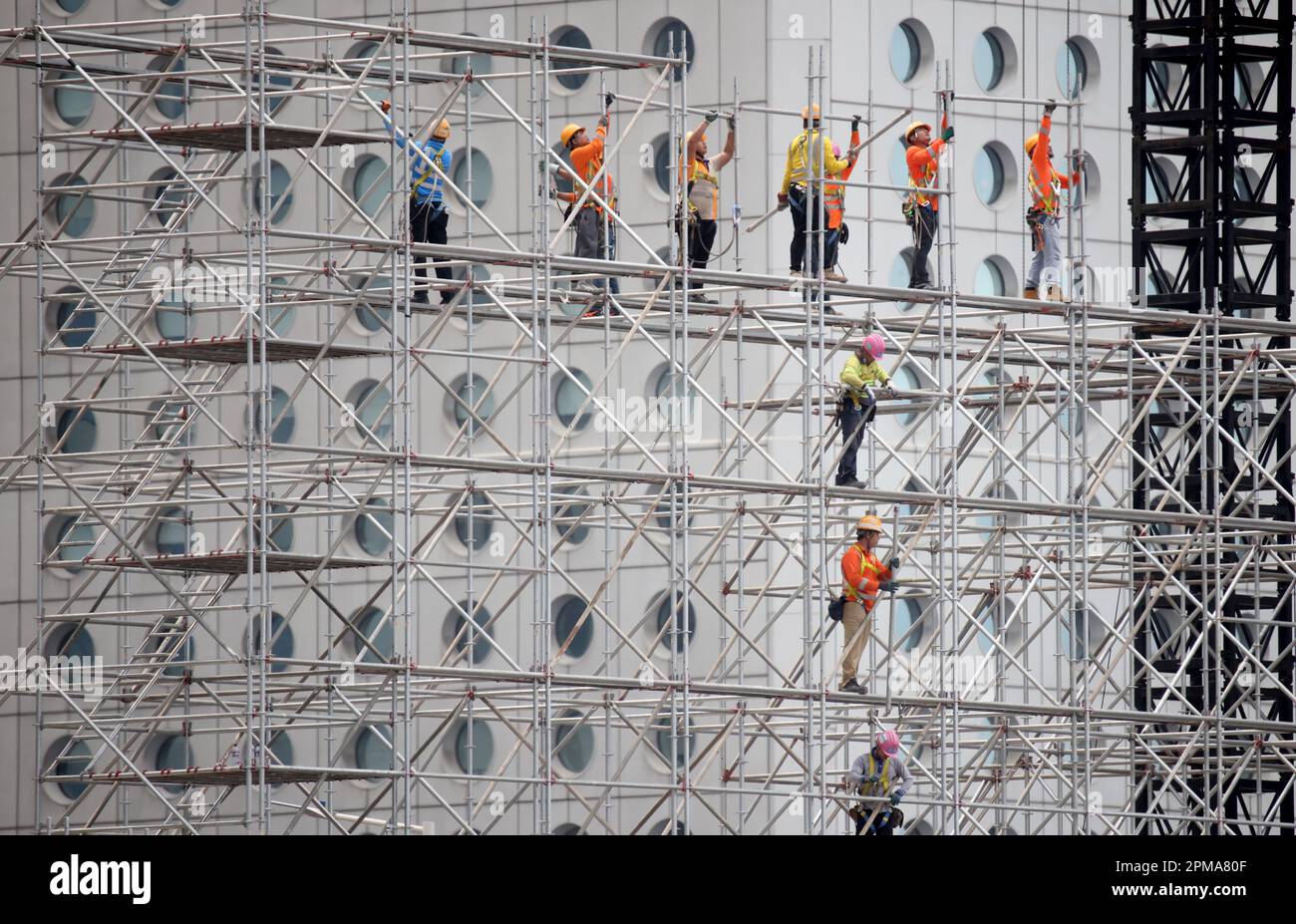 Workers setup the removable stage for coming concert at Central ...