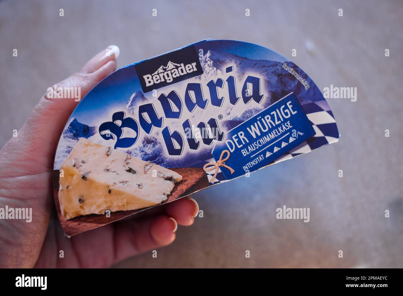 Tallinn, Estonia - April 3, 2023: Hand holding Bavaria blu cheese by ...