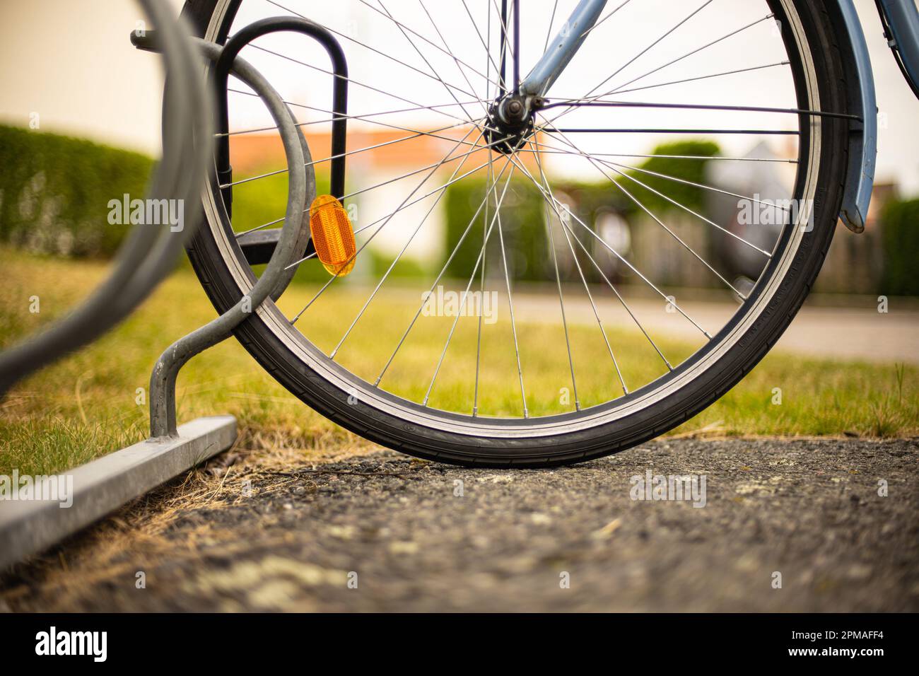 Detail of a front bicycle wheel locked to a bicycle stand Stock Photo ...
