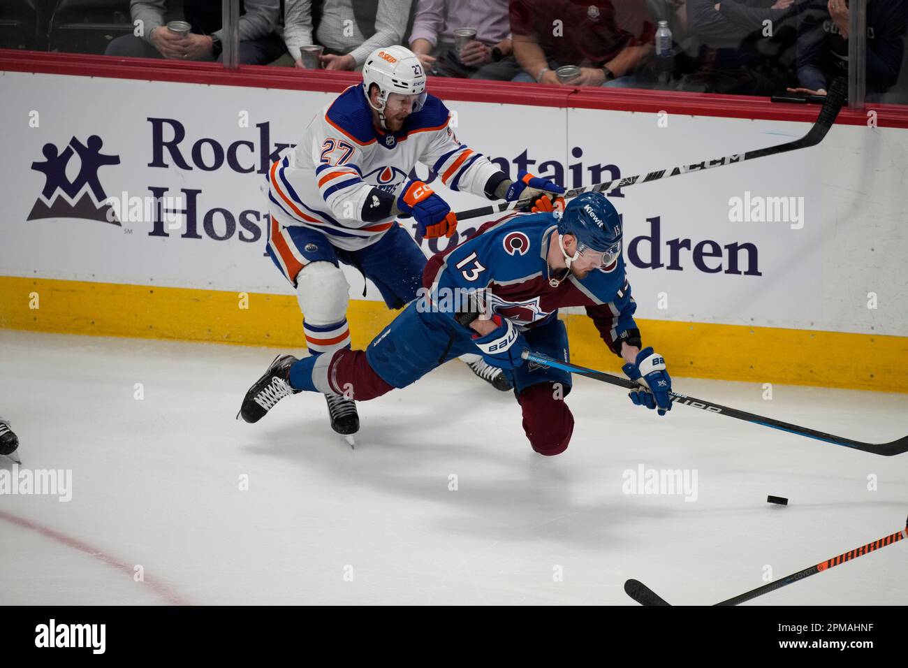 Edmonton Oilers defenseman Brett Kulak (27) checks Colorado Avalanche ...