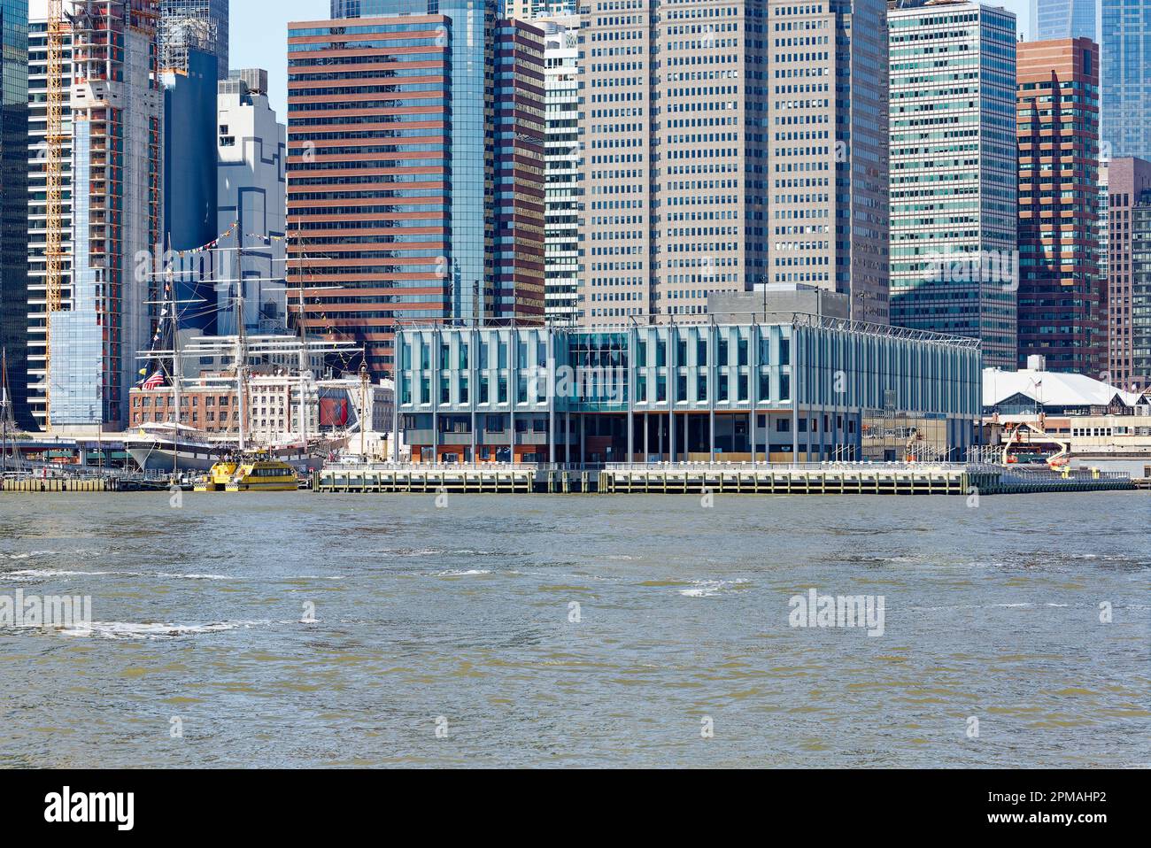 Pier 17 at South Street Seaport juts into the East River, with red-and ...