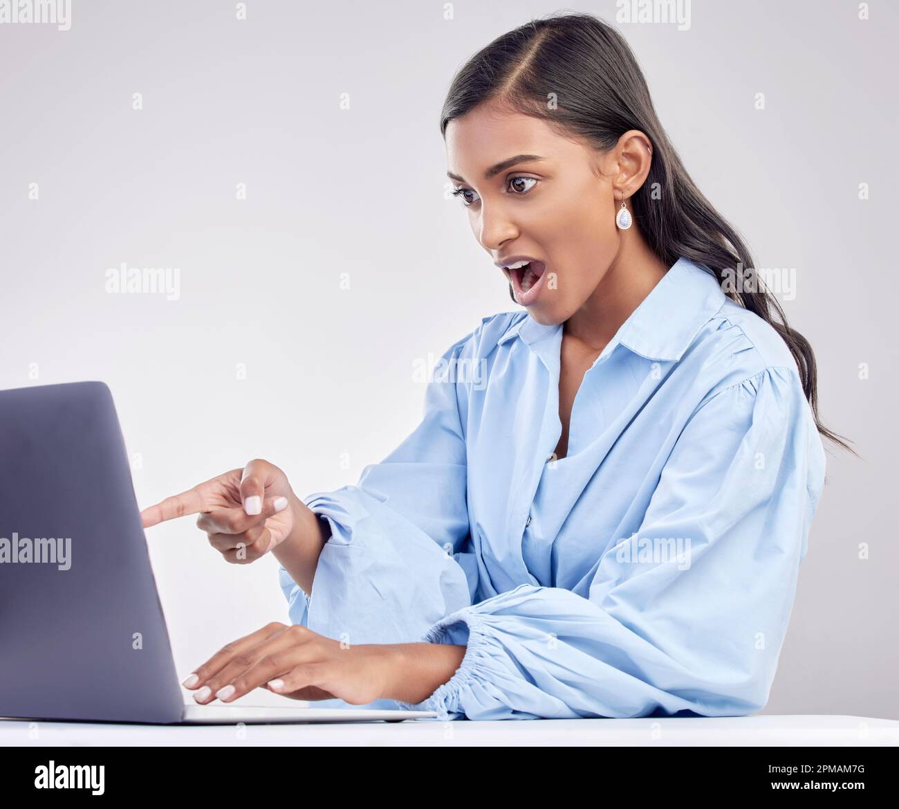 Shock, laptop and a pointing business woman in shock on a white ...