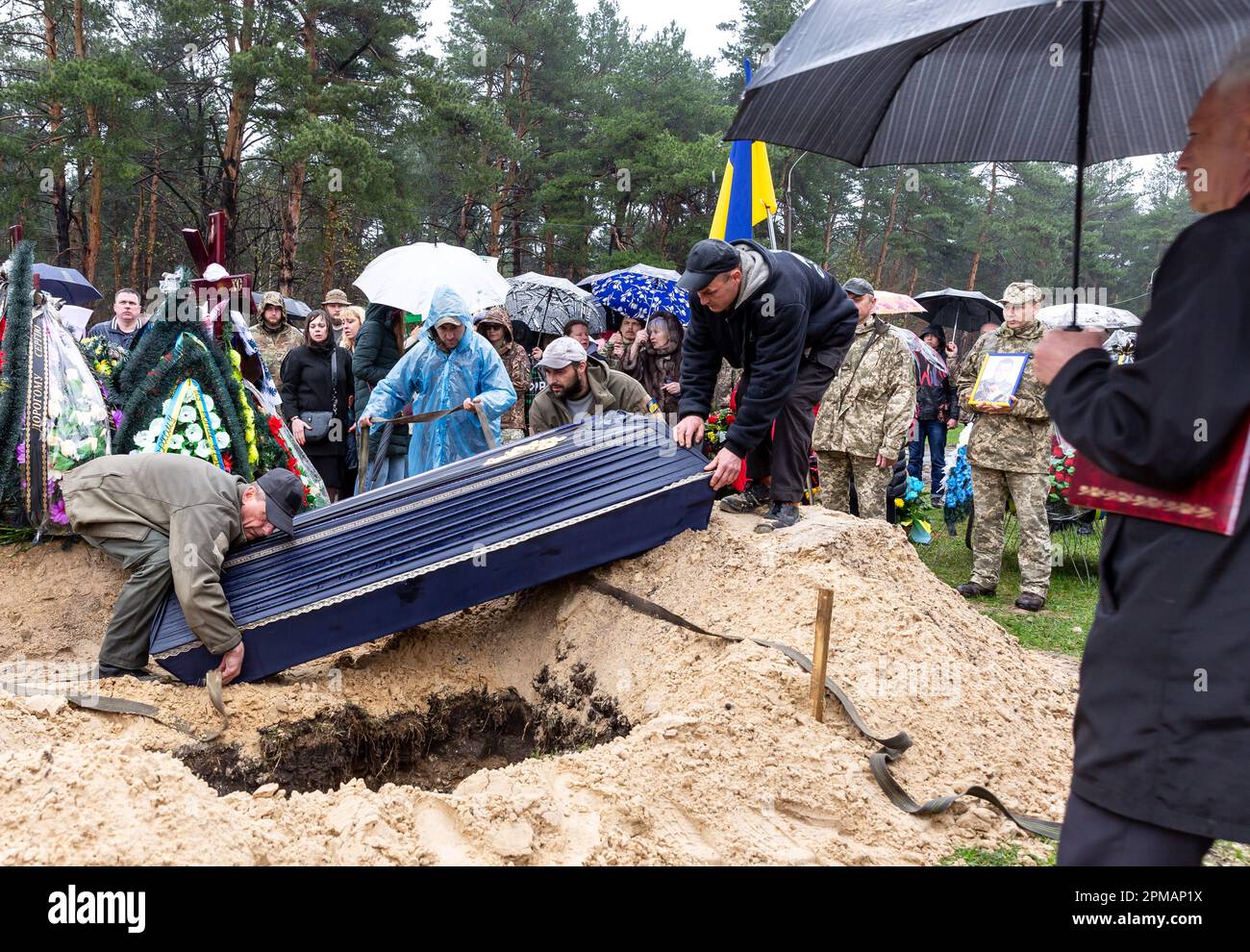 Servicemen lie the coffin during the funeral of Evgeny Yakovlev, 42, a ...