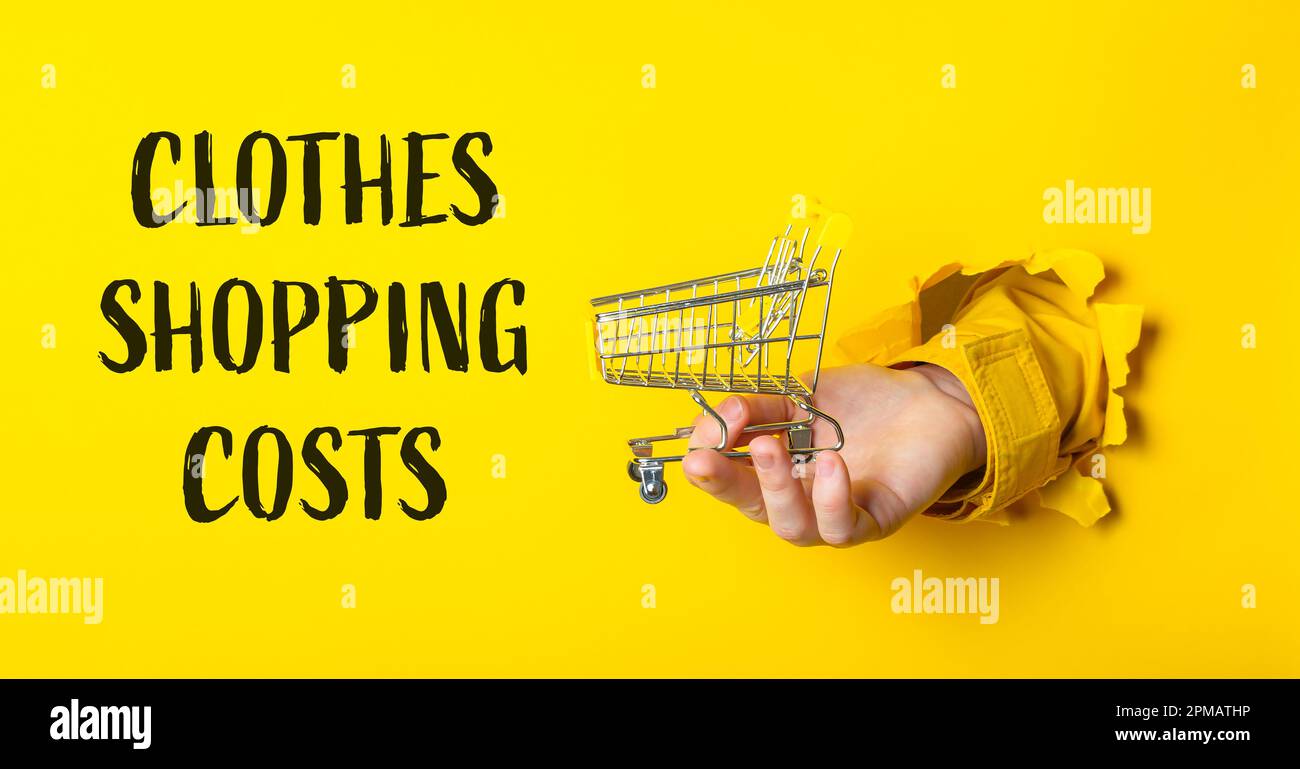 Clothes Shopping Costs text on yellow background Stock Photo - Alamy