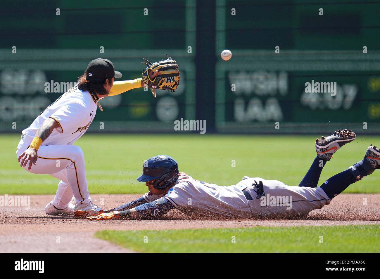 Houston Astros' Mauricio Dubon, right, slides safely into second with a ...