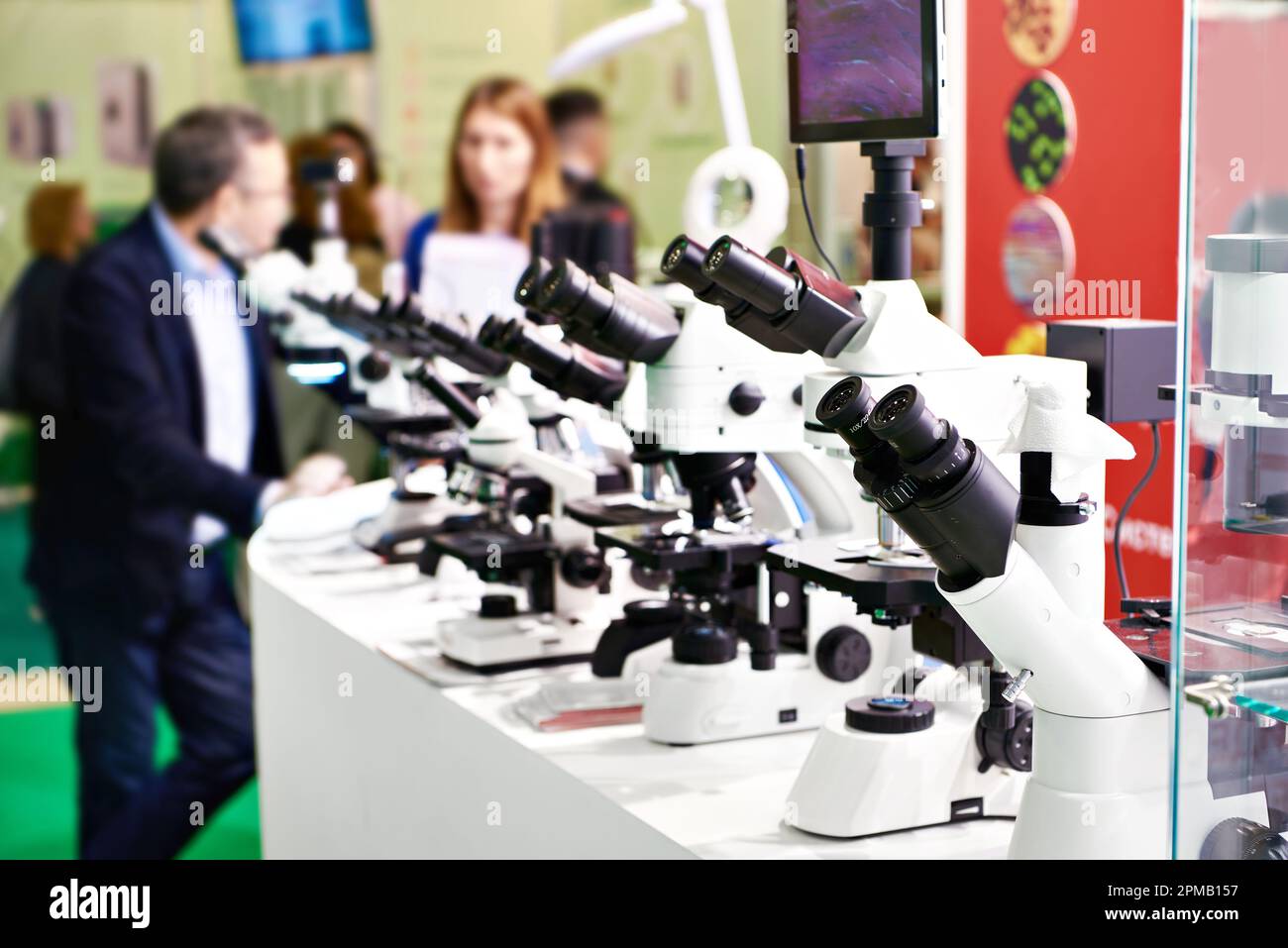 People and microscopes at an exhibition Stock Photo - Alamy