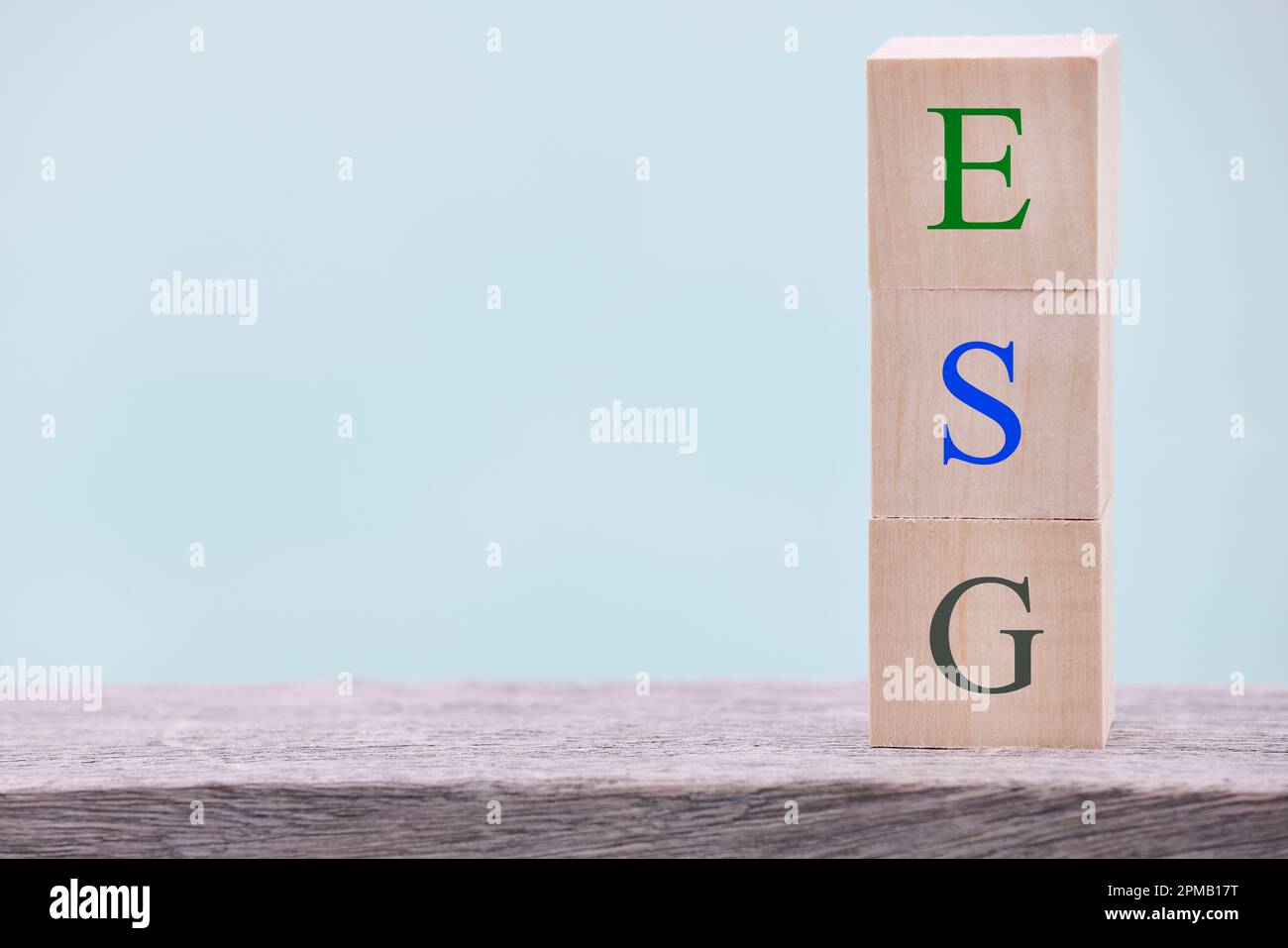 ESG words on wooden cube on blue background.copy space. Environmental ...