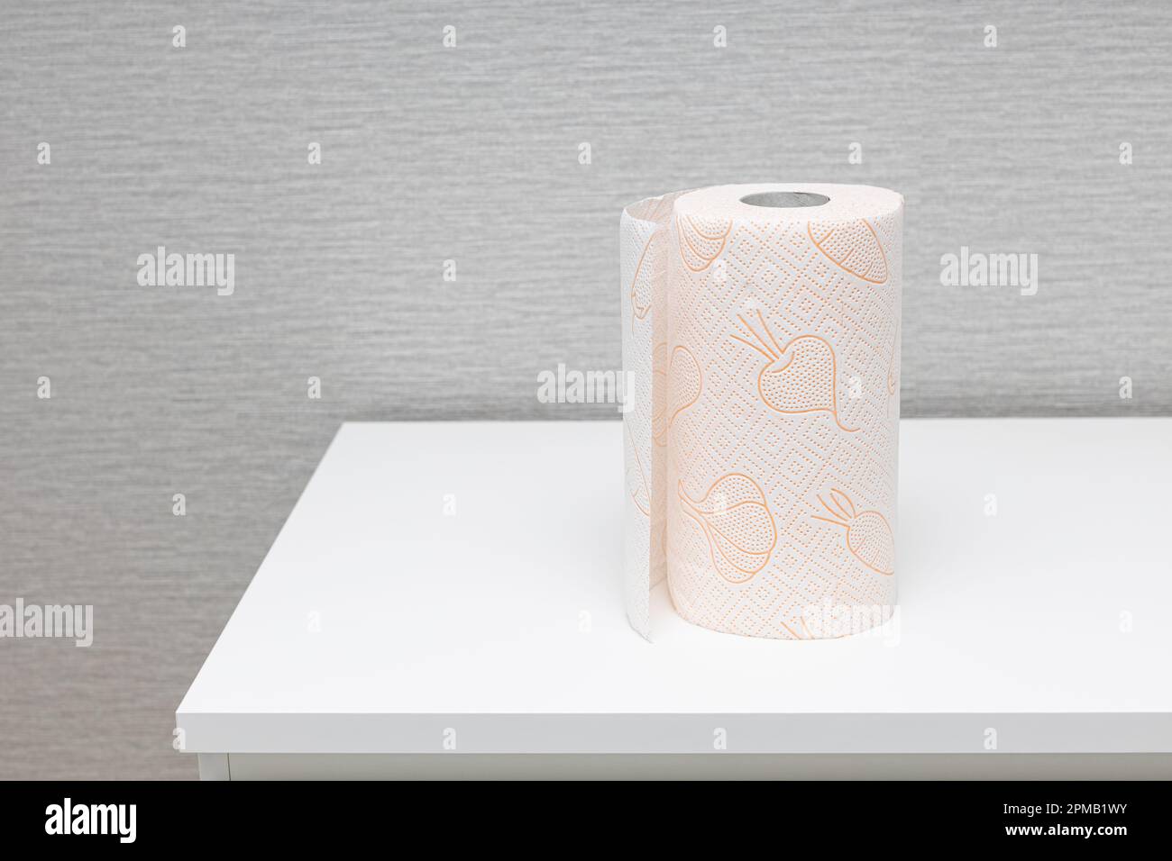 a roll of paper towel lies on a white table. patterned paper towel ...
