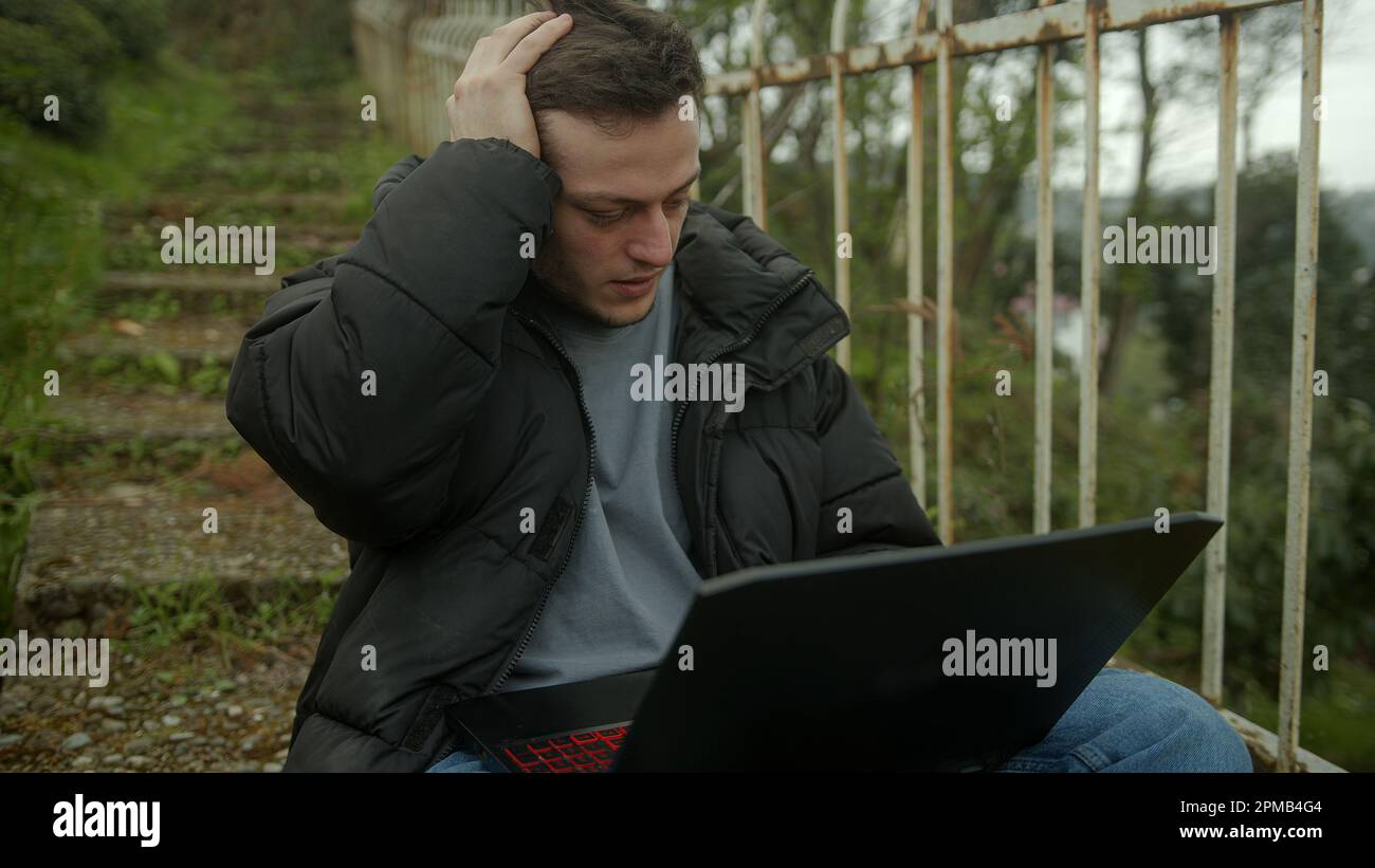 Man outside checking his credit card on the laptop went mad when he ...