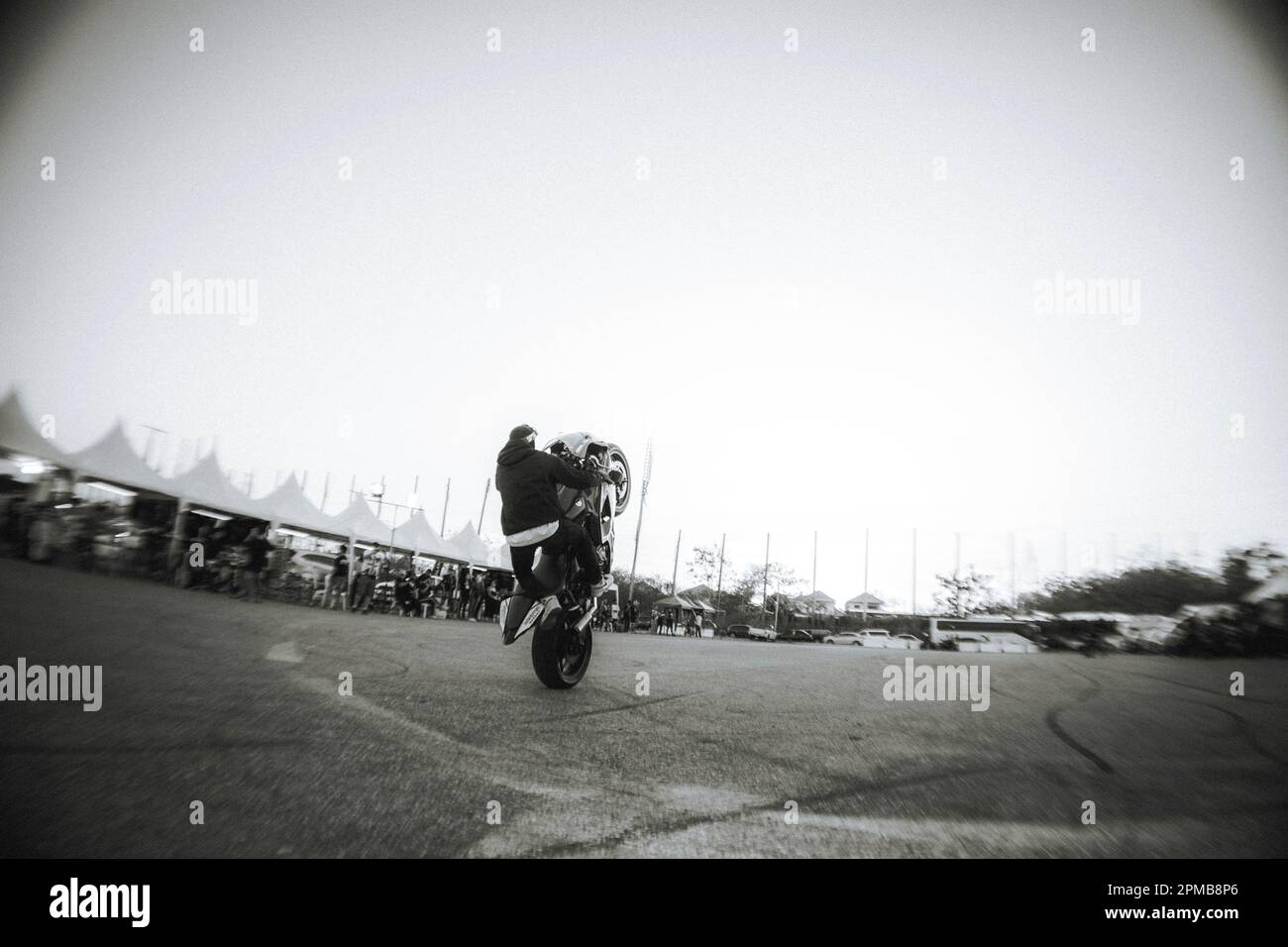 Motorcycle stuntman back wheel stand Stock Photo - Alamy