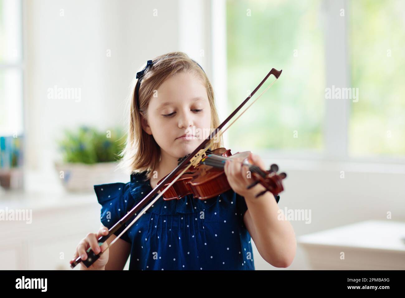 Child playing violin. Remote learning from home. Arts for kid. Little ...