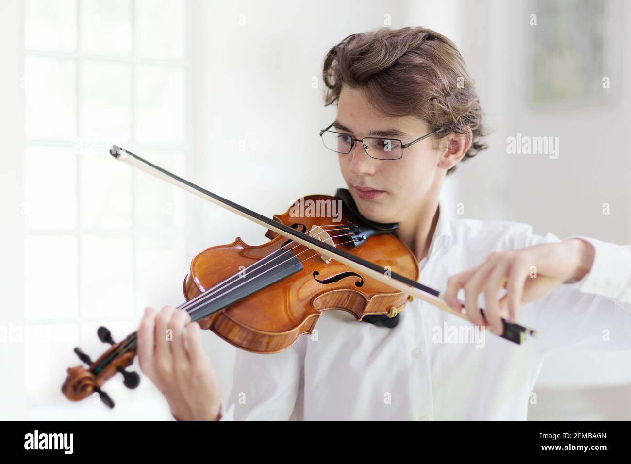 Man playing violin. Classical music instrument. Teenage boy practicing ...
