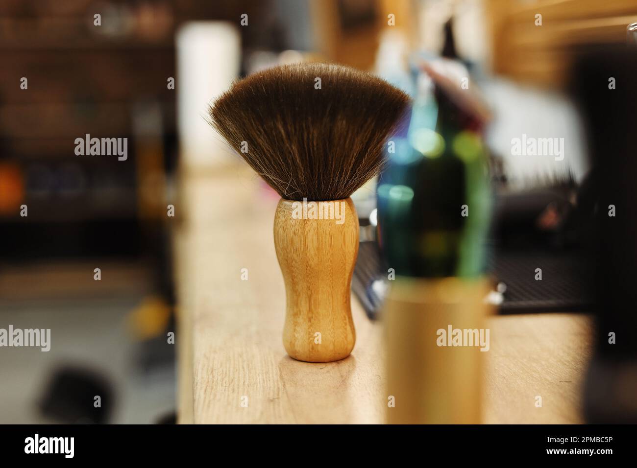 Fluffy retro black shaving brush with wooden handle on wooden work ...