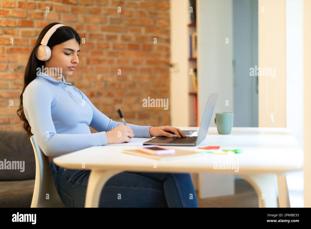 Distance learning concept. Teenager lady studying with laptop, taking ...