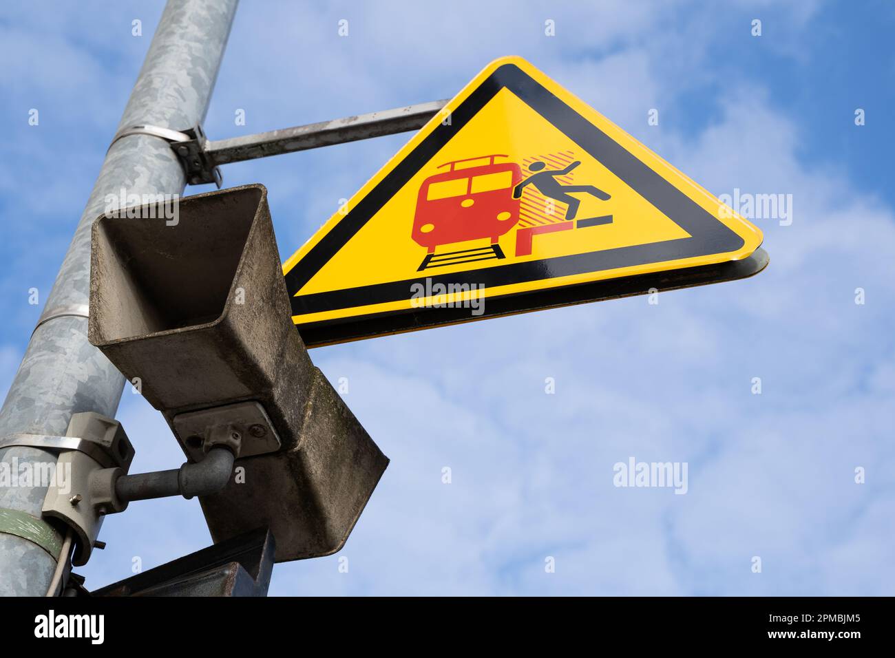 Announcement speaker and yellow triangular warning sign for passengers ...