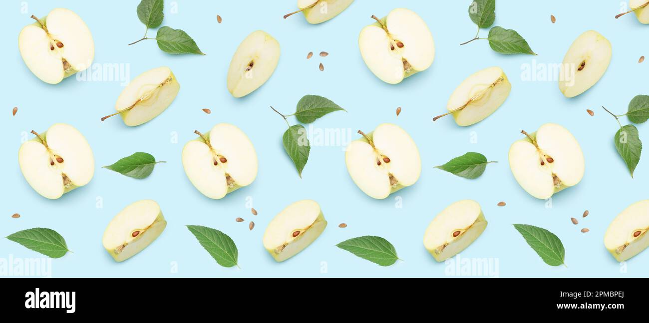 Many cut apples on light blue background. Pattern for design Stock ...