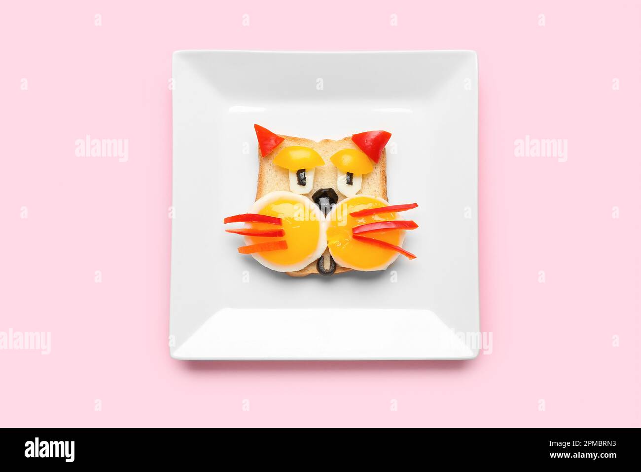Plate with funny children's breakfast in shape of cat on pink ...