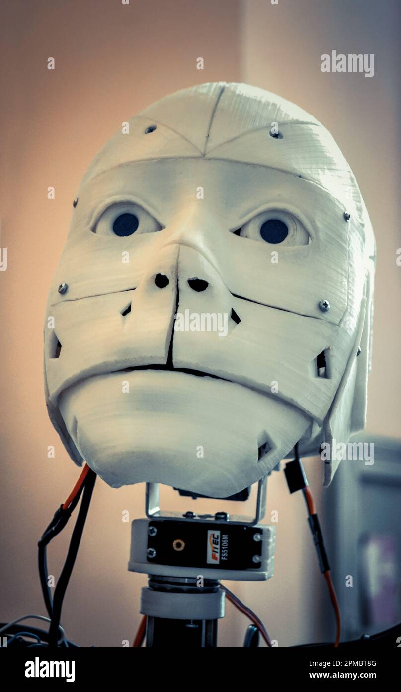 Face robot close-up. Face of an old robot made of white shabby plastic ...
