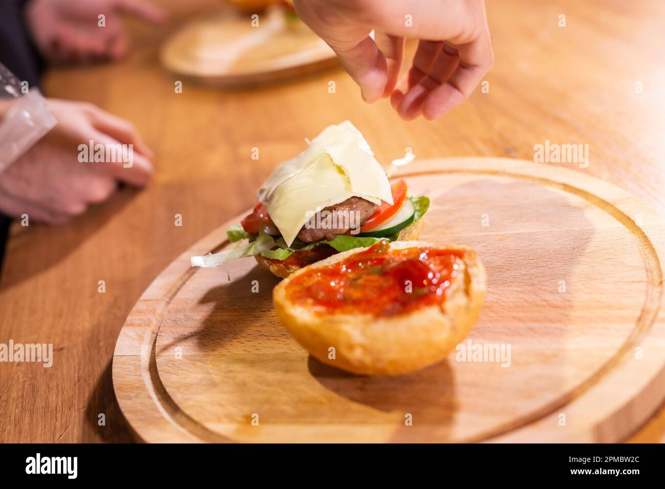 Preparing delicious burgers. Chef cooking meat burgers with beef ...