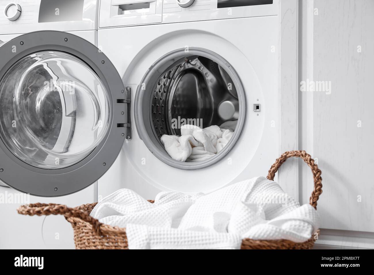 Modern washing machines with dirty clothes in laundry room Stock Photo ...