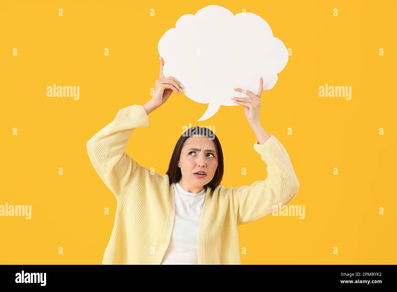 Upset young woman with blank speech bubble on yellow background Stock ...