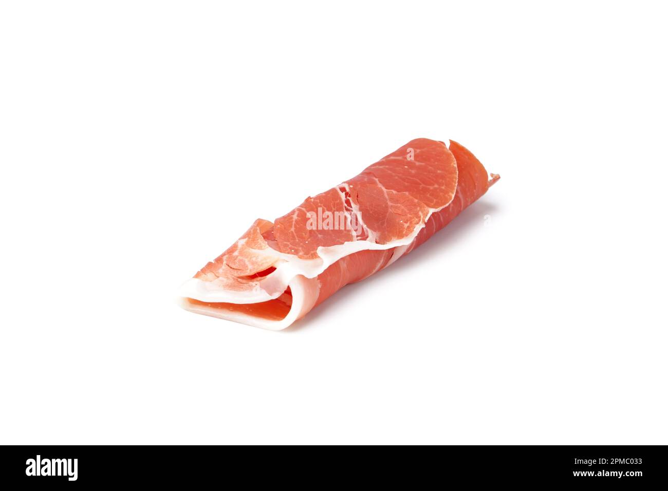 Tasty jamon slice on white background Stock Photo - Alamy