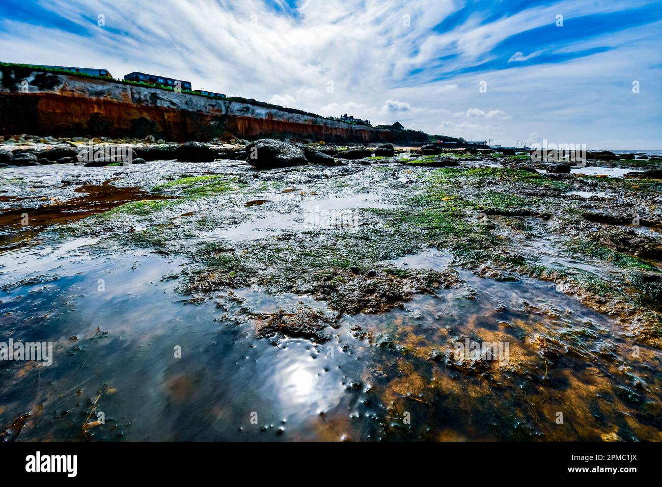 Sunny day Hunstanton beach cliffs reflections water Stock Photo - Alamy