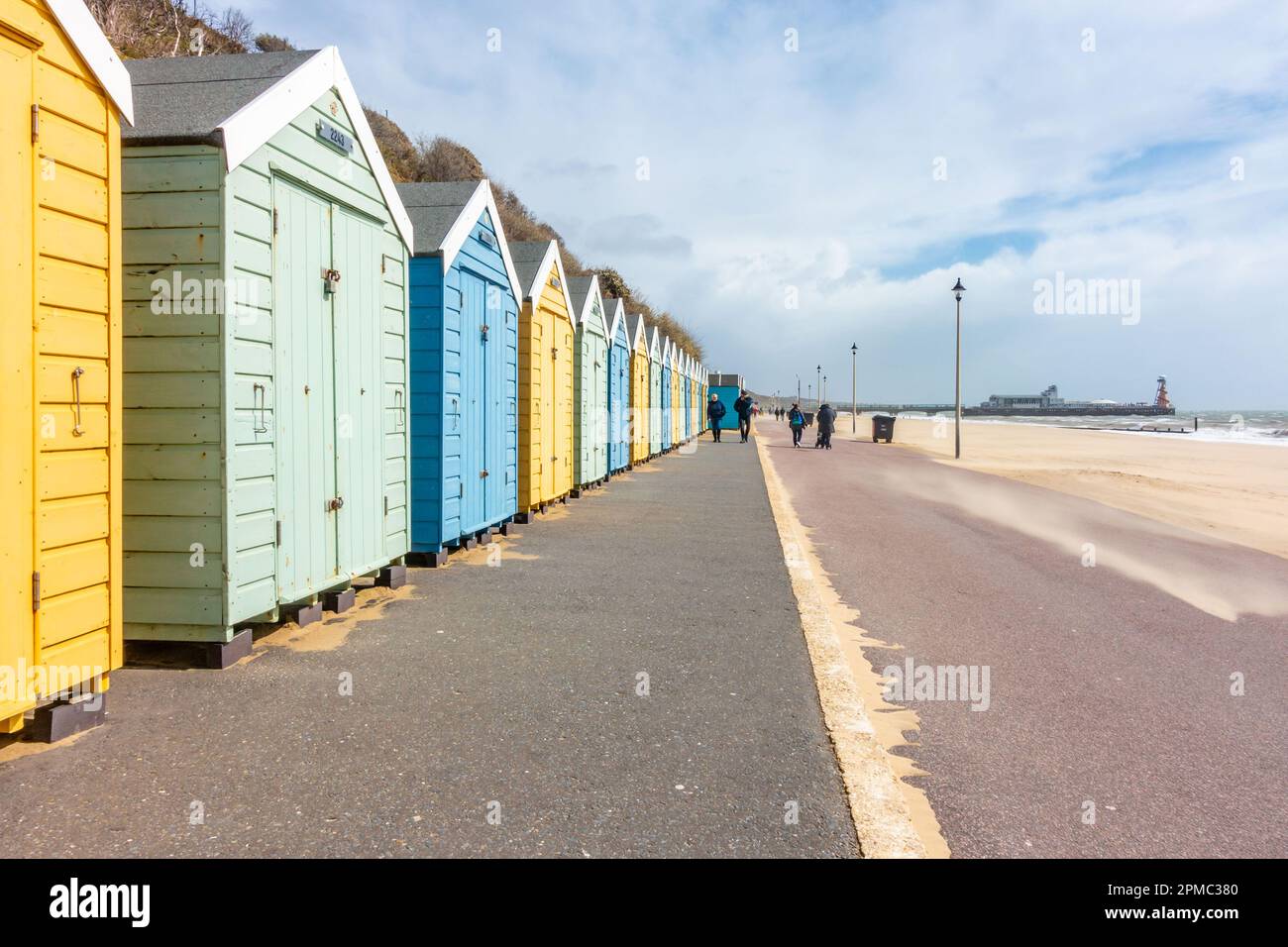 A path in front of beach huts on Bournemouth Beach in Dorset, UK under ...