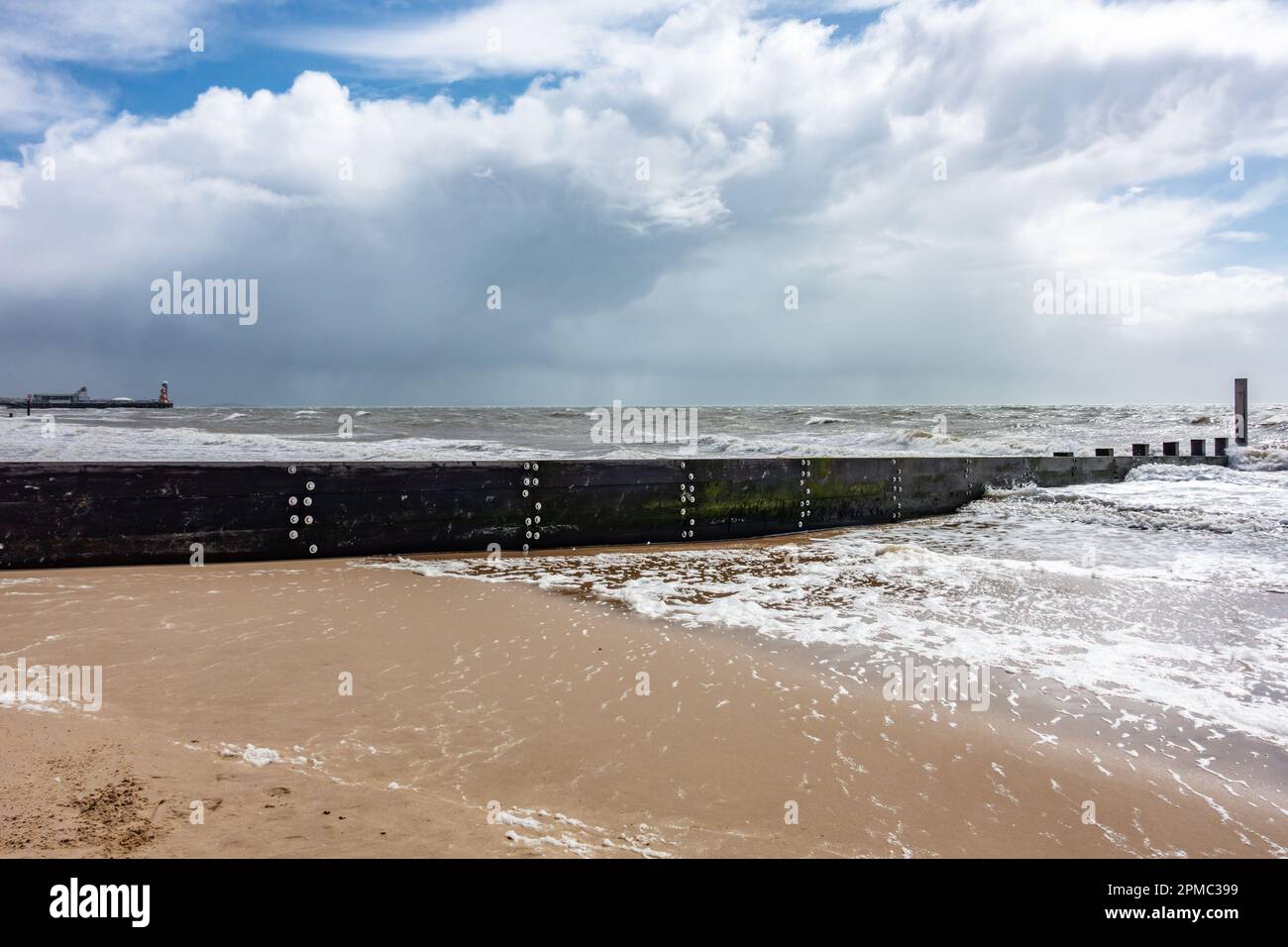A groyne reaching out into the sea, perpendicular to the shoreline on ...