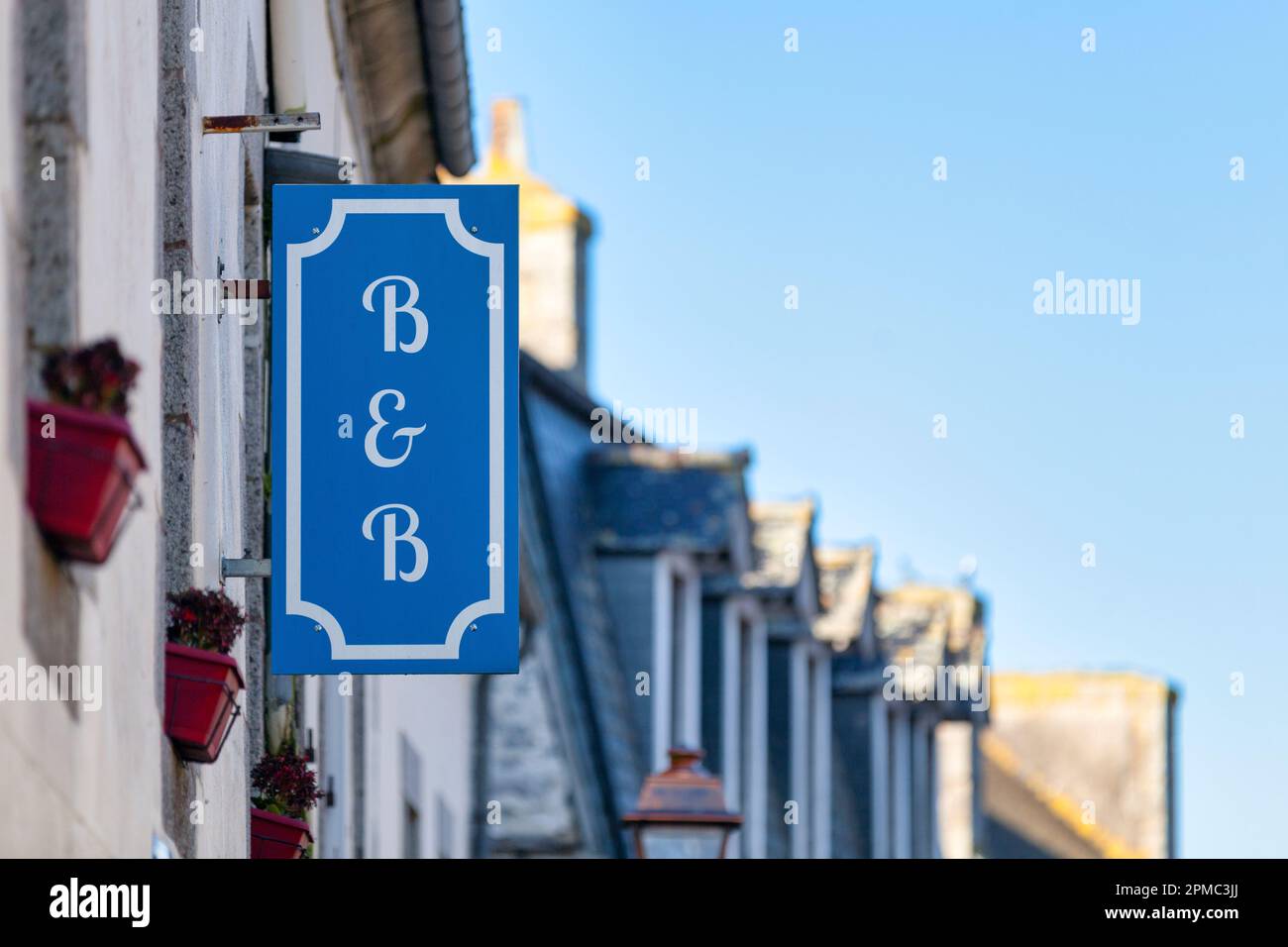 Blue bed and breakfast sign above a building entrance Stock Photo - Alamy