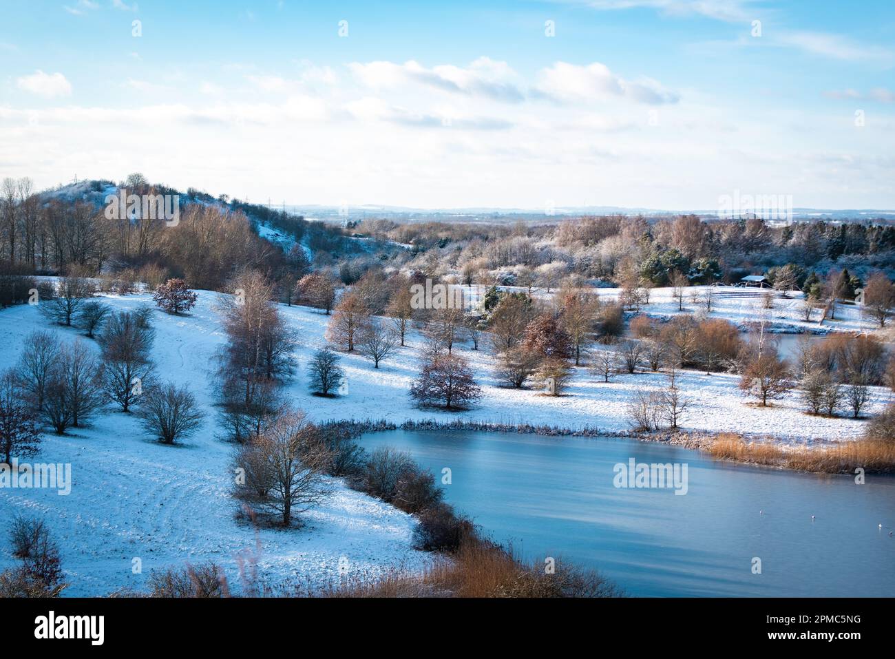 Snow covered landscape with a lake in the middle in the winter of ...