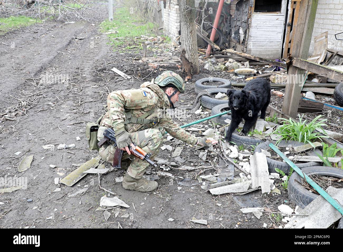 DONETSK REGION, UKRAINE - APRIL 12, 2023 - A Ukrainian serviceman feeds ...