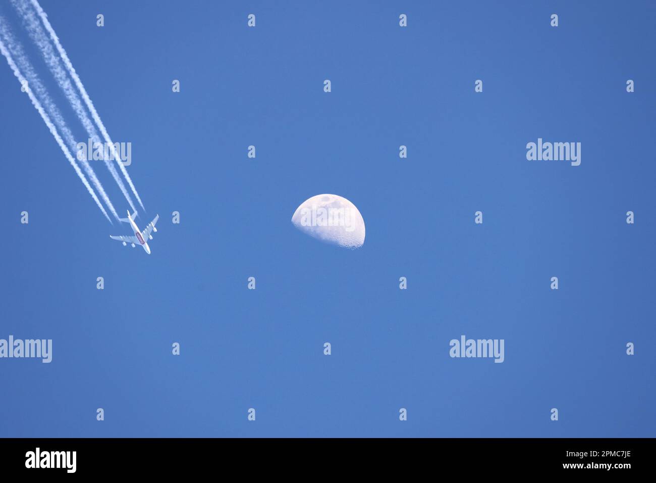 A Jet Flying Under a Full Moon at Night, Color Image Stock Photo - Alamy