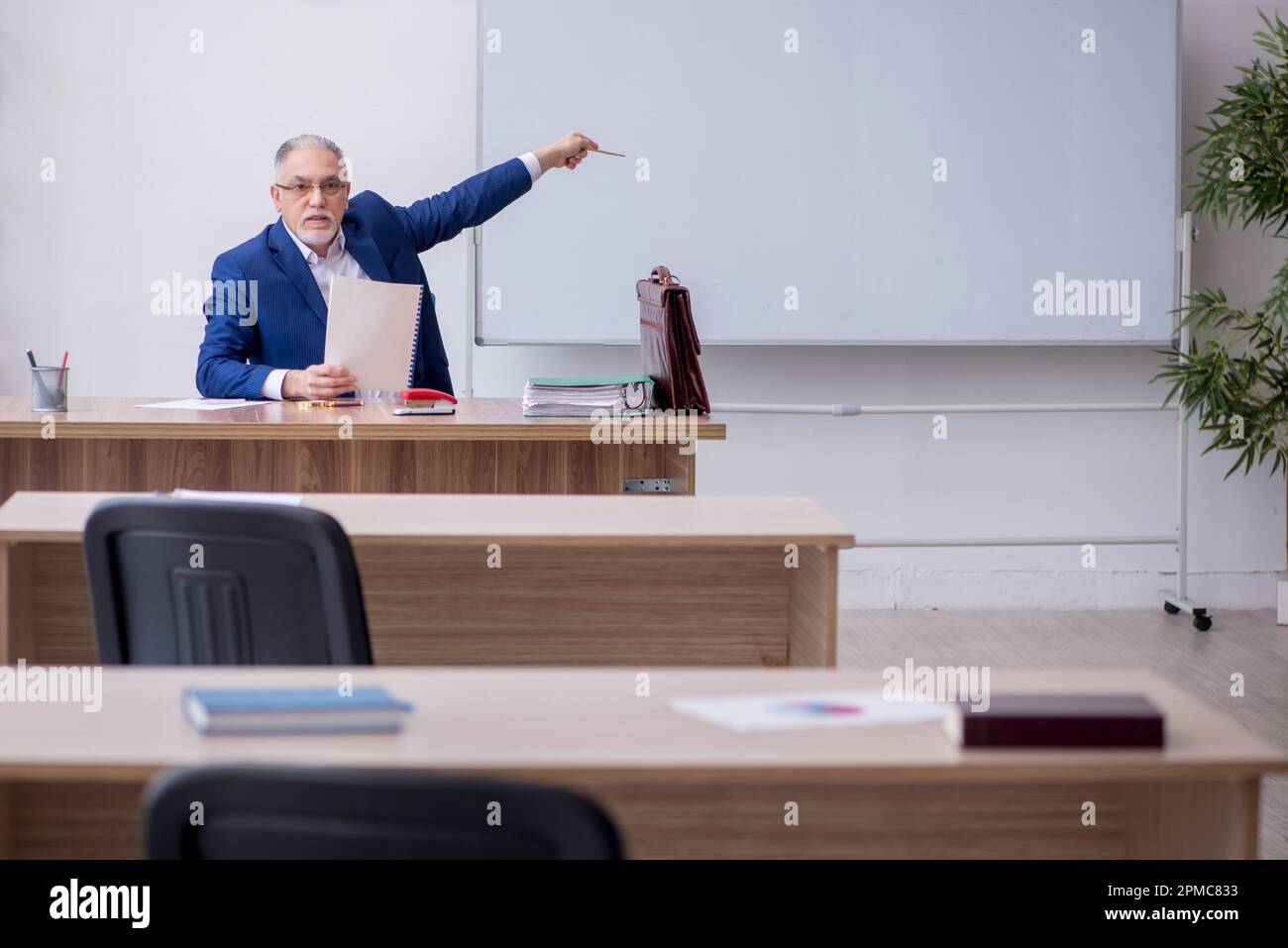 Old teacher in the classroom Stock Photo - Alamy