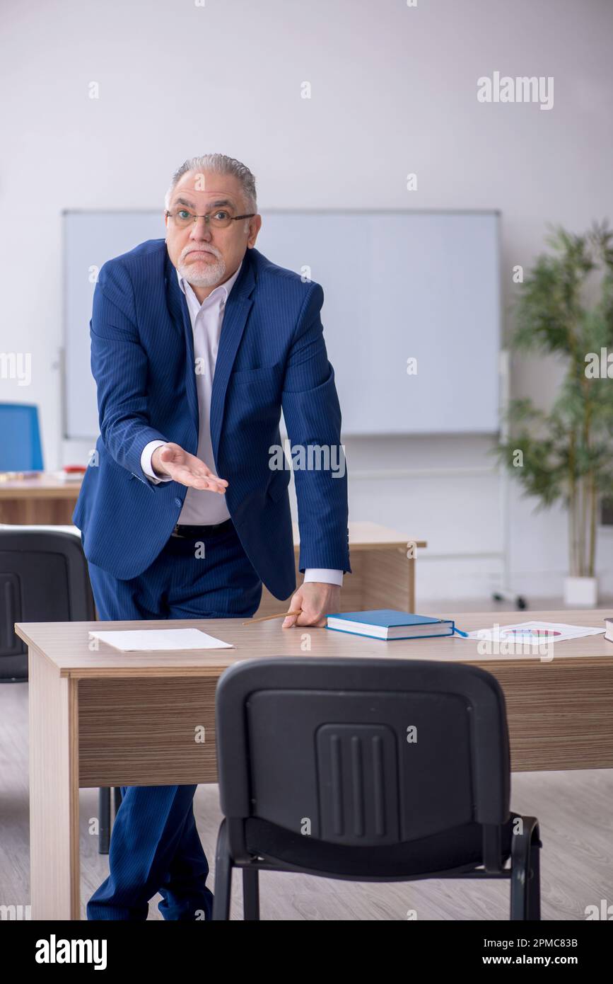 Old teacher in the classroom Stock Photo - Alamy
