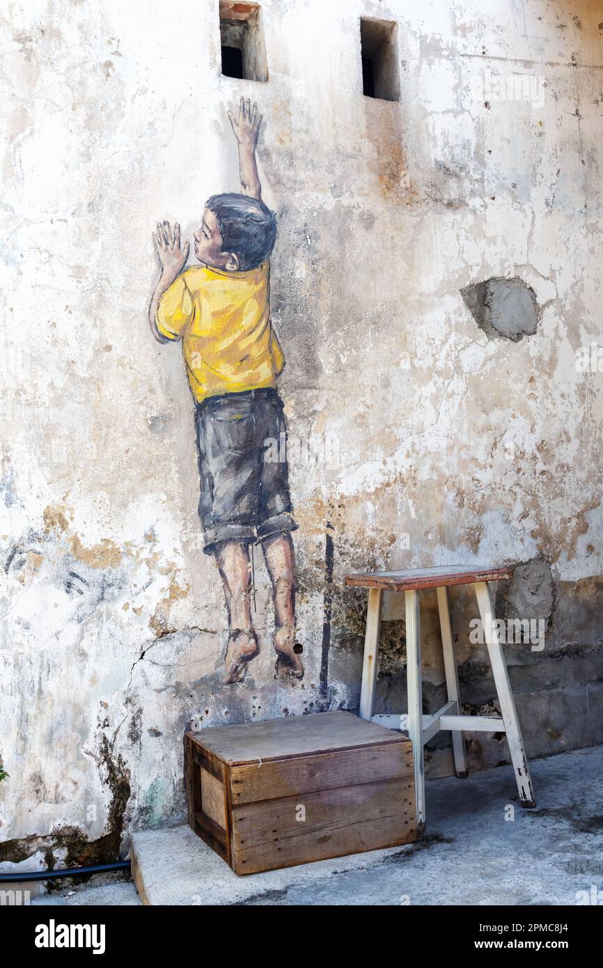 Street Art mural boy Reaching Up on a wall portrait format in George ...