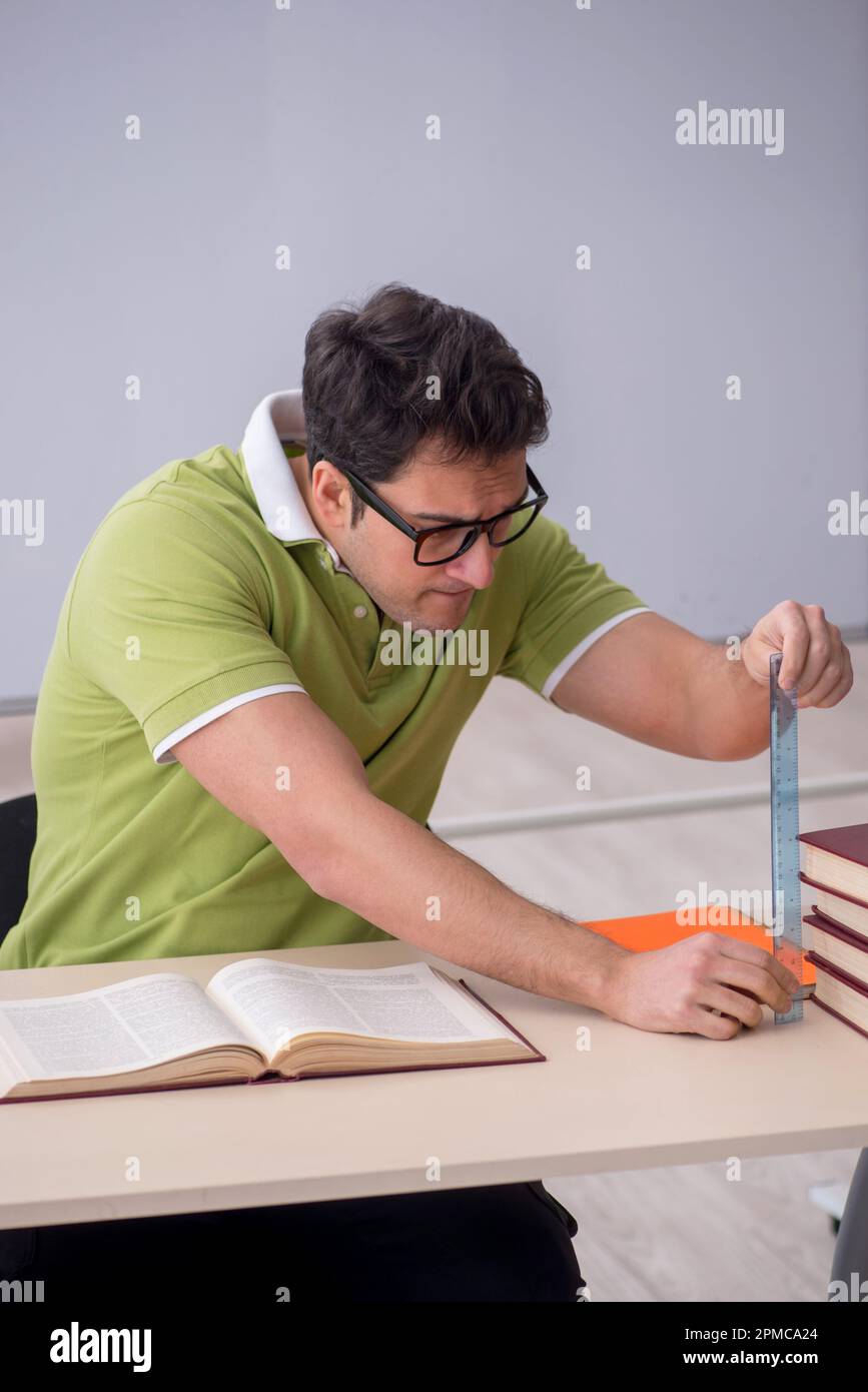 Young student sitting in the classroom Stock Photo - Alamy