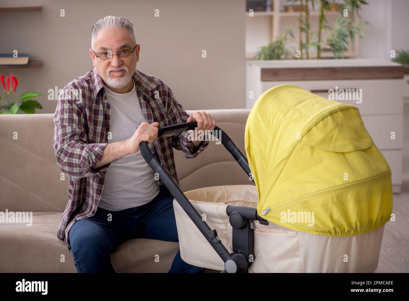 Man looking after baby hi-res stock photography and images - Alamy