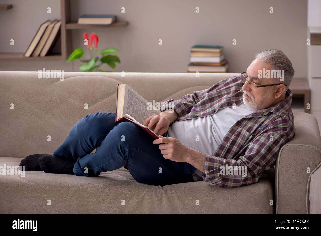 Old man reading book at home during pandemic Stock Photo - Alamy