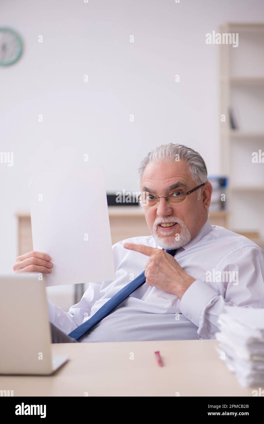Old boss employee working at workplace Stock Photo - Alamy